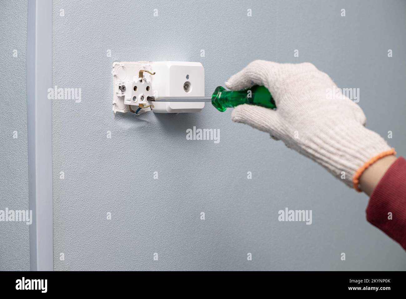 master repairing electrical outlet in the house Stock Photo - Alamy