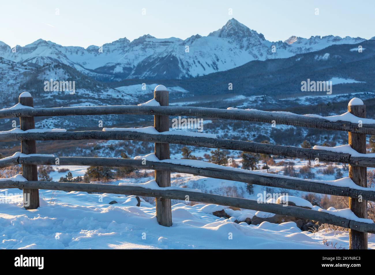 Snow covered fence in winter mountains Stock Photo - Alamy