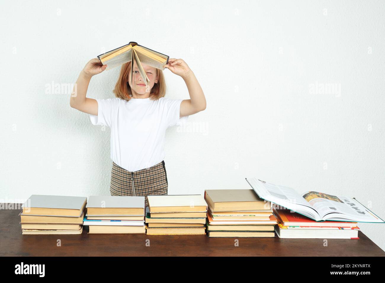 Education concept. The student holds an opened book and holds it down ...