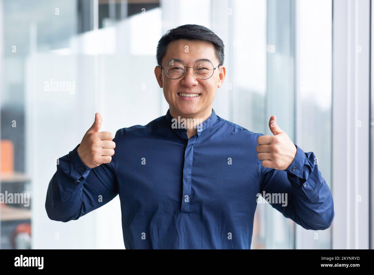 Portrait of successful asian man inside office near window, boss in ...