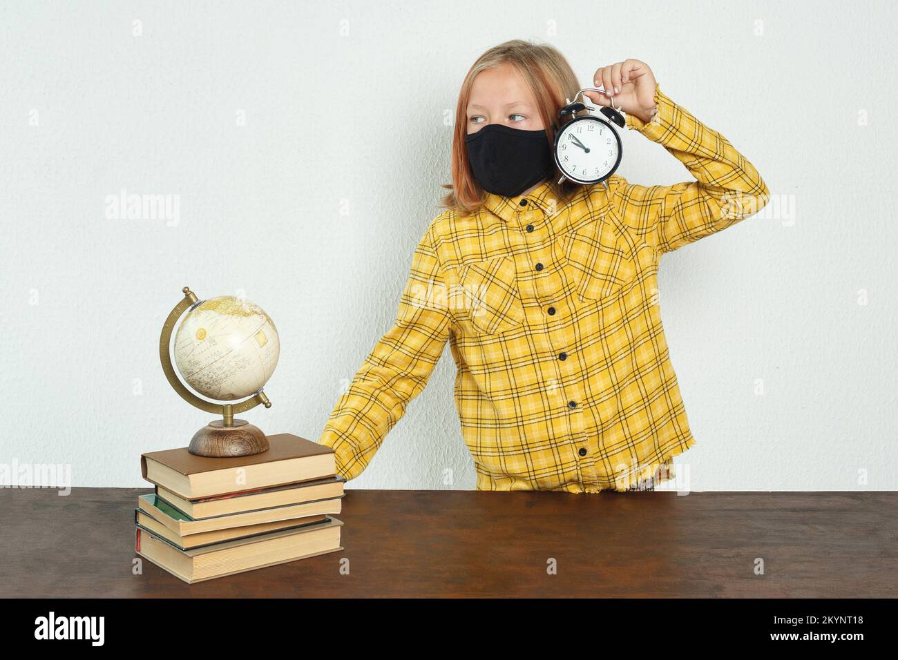 Clock on globe hands hi-res stock photography and images - Alamy