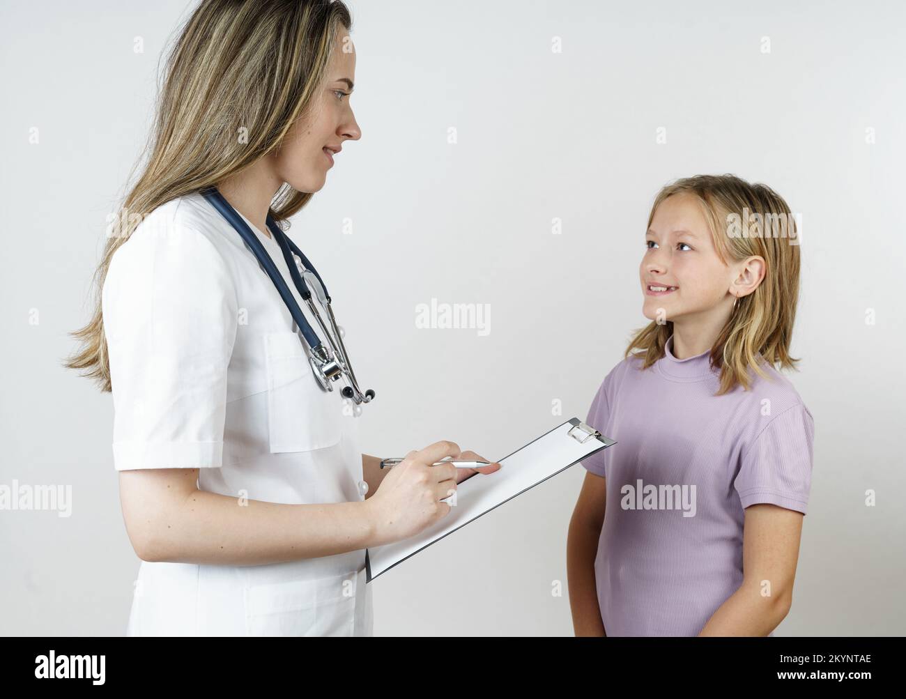 Medicine and health concept. A young female doctor takes a teenage girl ...