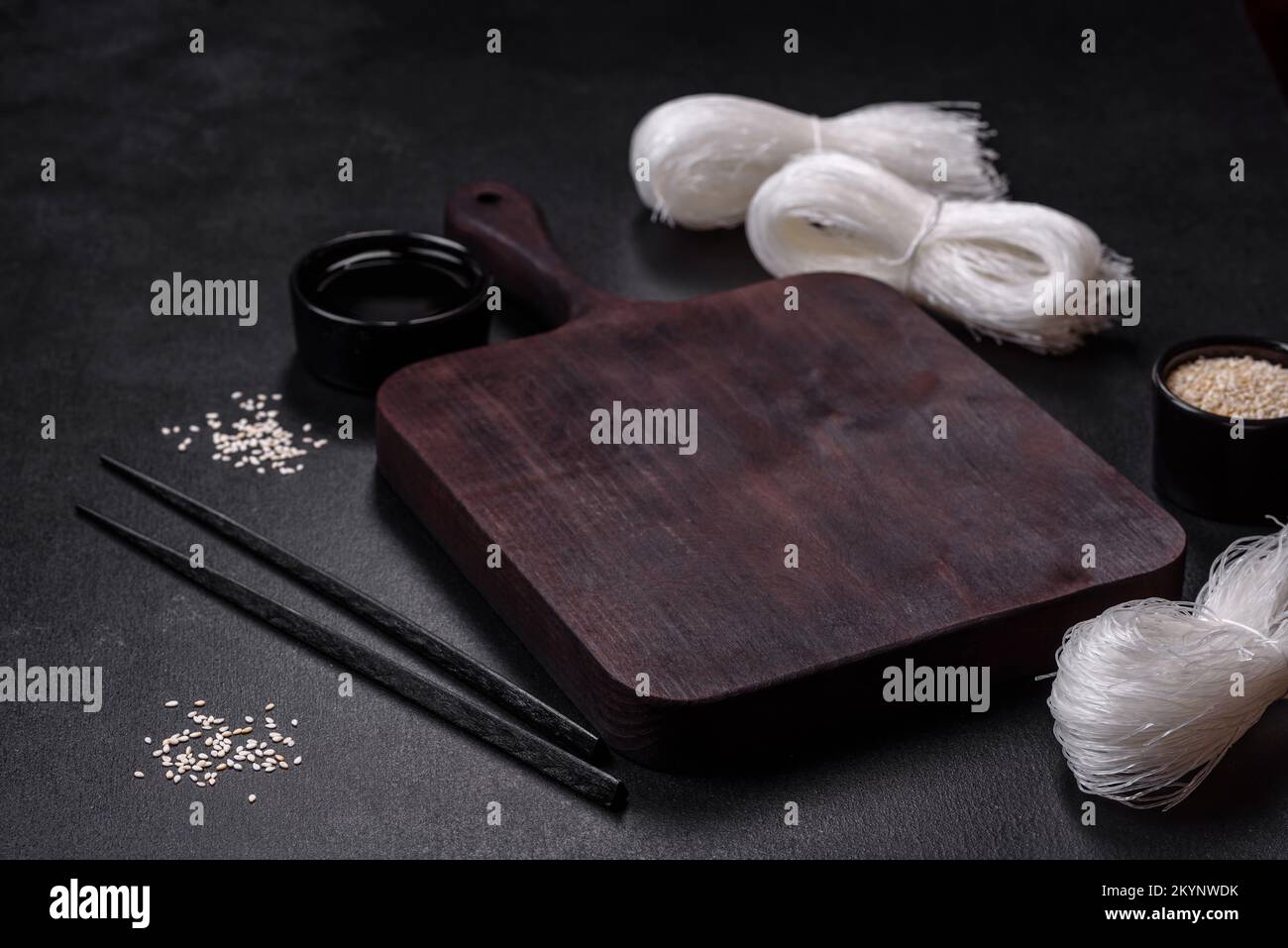 Empty plate with wooden sticks for Asian food on a dark concrete ...