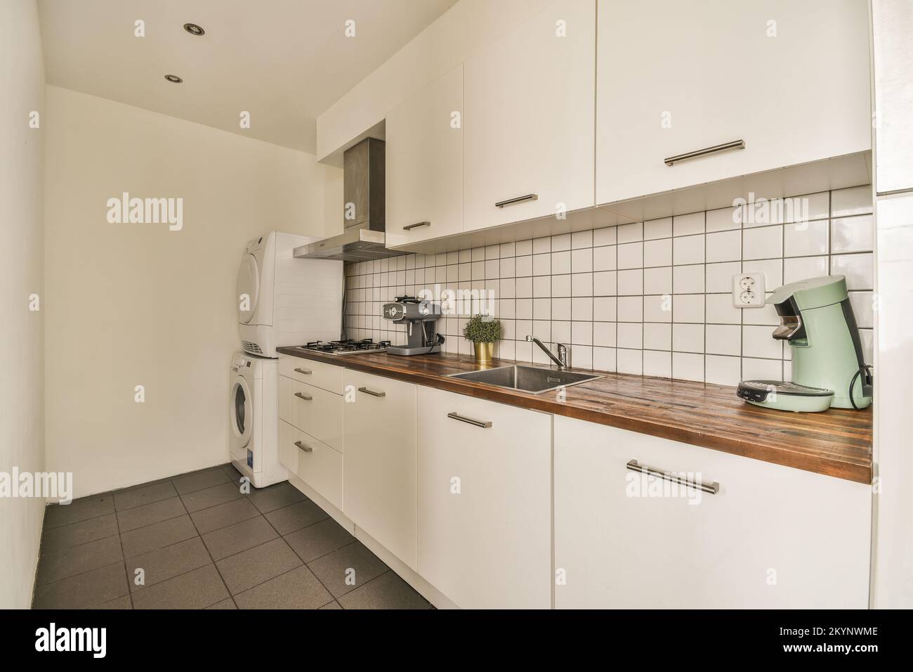 Table with chairs and flowers located near lounge area and kitchen in ...