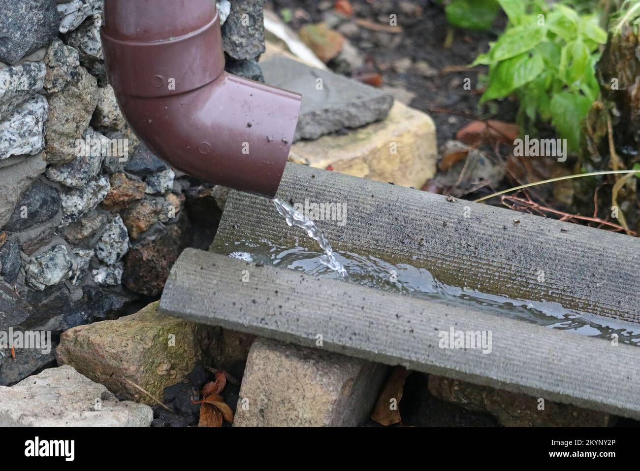 Rain water flows out of the gutter pipe. Roof gutter system on the ...
