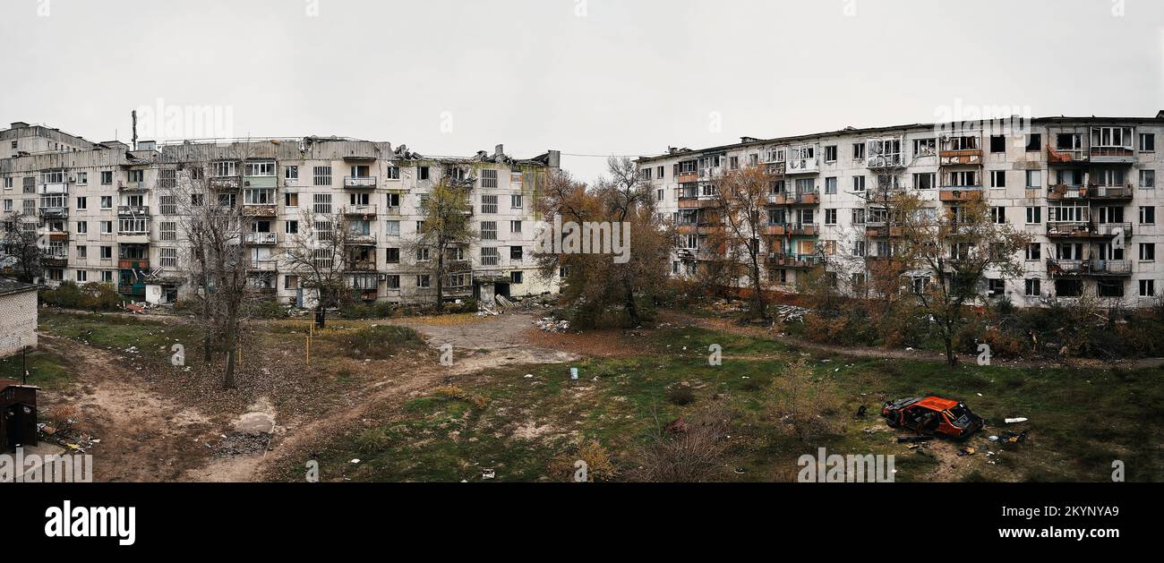 The yard of destroyed apartment buildings in the war zone. Damage to a ...