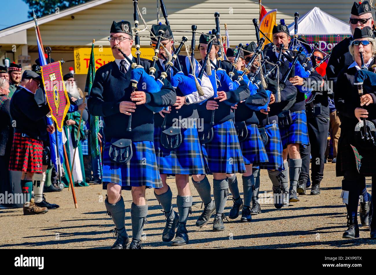 Scottish pipers play the bagpipes as they march in the parade of ...