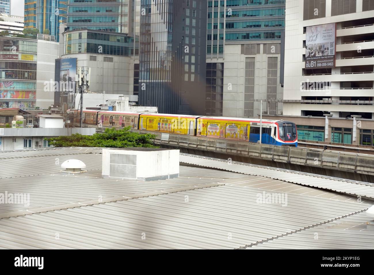 A BTS metro train (Skytrain) going from Phrom Phong station to Asok ...