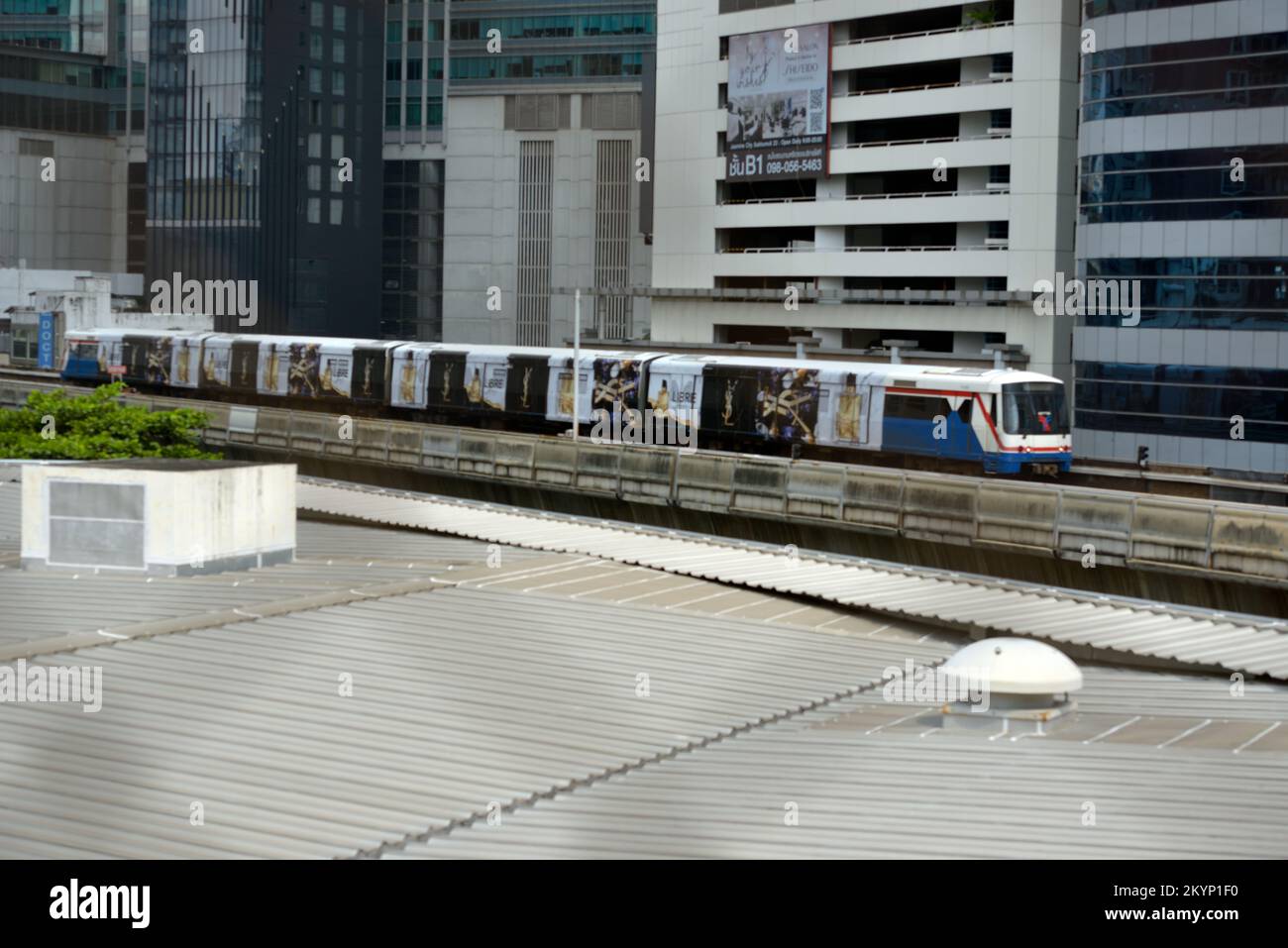 A BTS metro train (Skytrain) going from Asok station to Phrom Phong ...