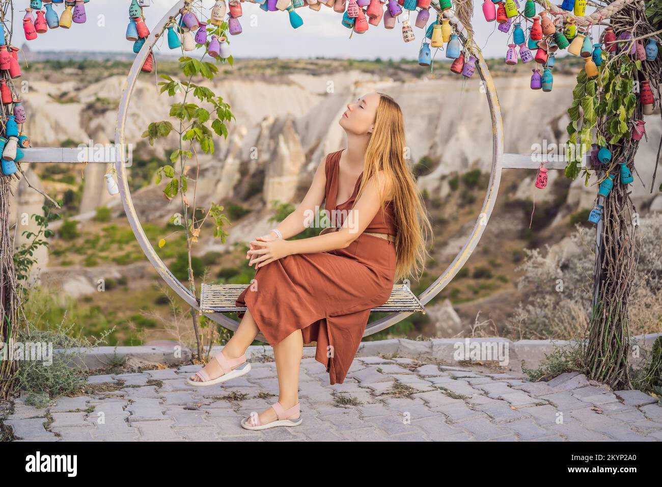 Young woman exploring valley with rock formations and fairy caves near ...