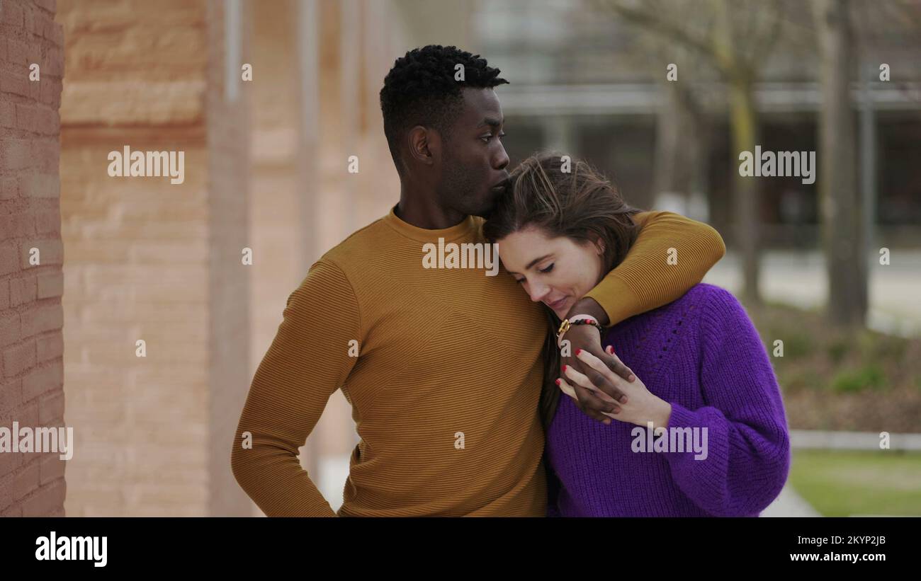 Young interracial couple walking together showing love and affection ...