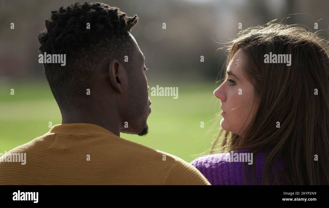 Young interracial kissing, back of two people kiss Stock Photo - Alamy