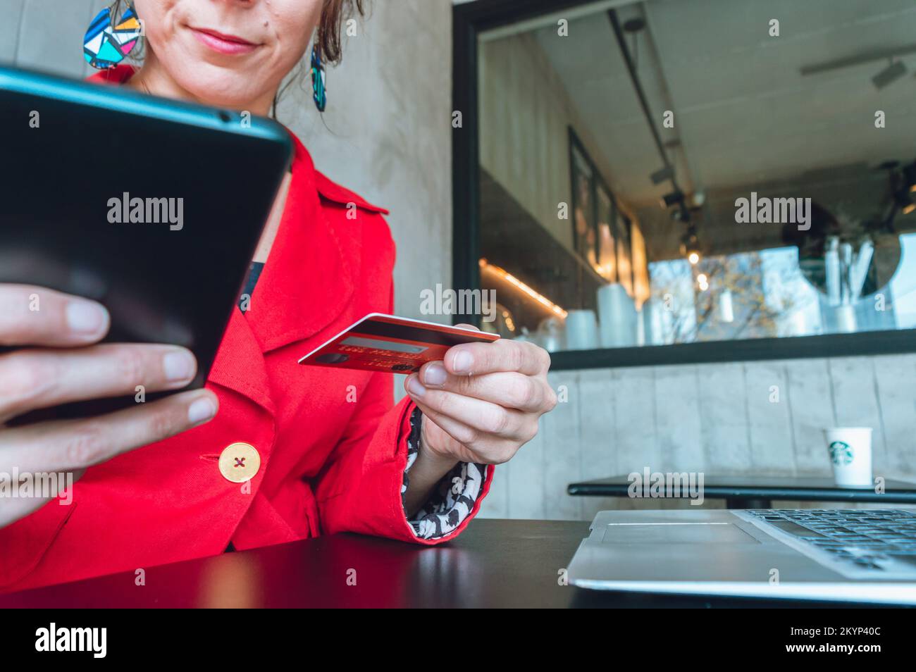 Unrecognizable caucasian business woman in a red blazer, using the ...