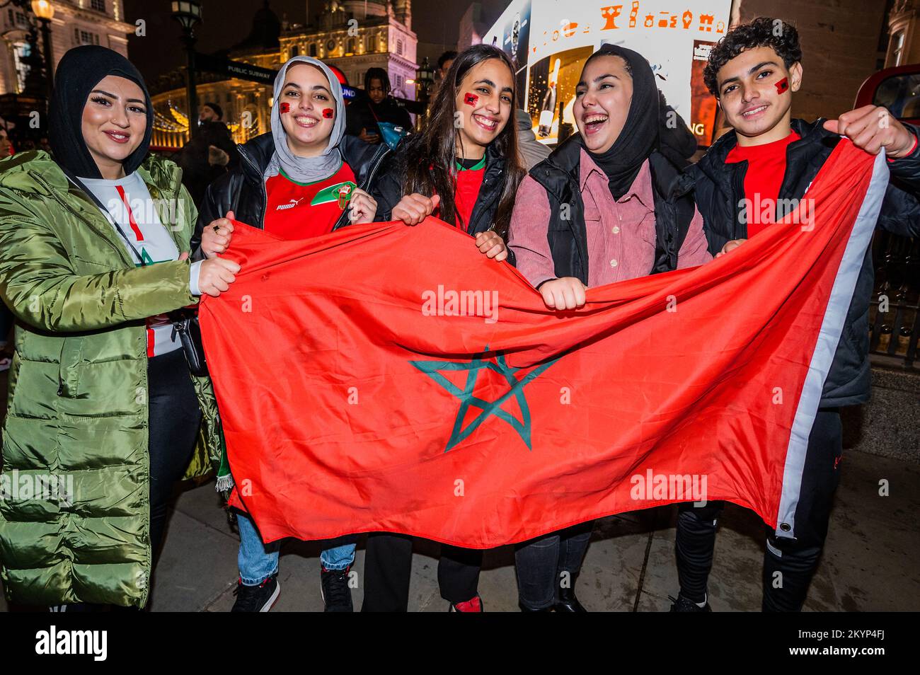 London, UK. 1st Dec, 2022. Moroccan fans in Piccadilly Circus celebrate ...