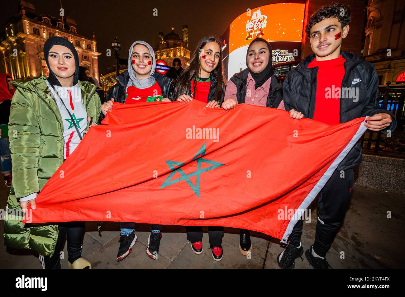 London, UK. 1st Dec, 2022. Moroccan fans in Piccadilly Circus celebrate ...