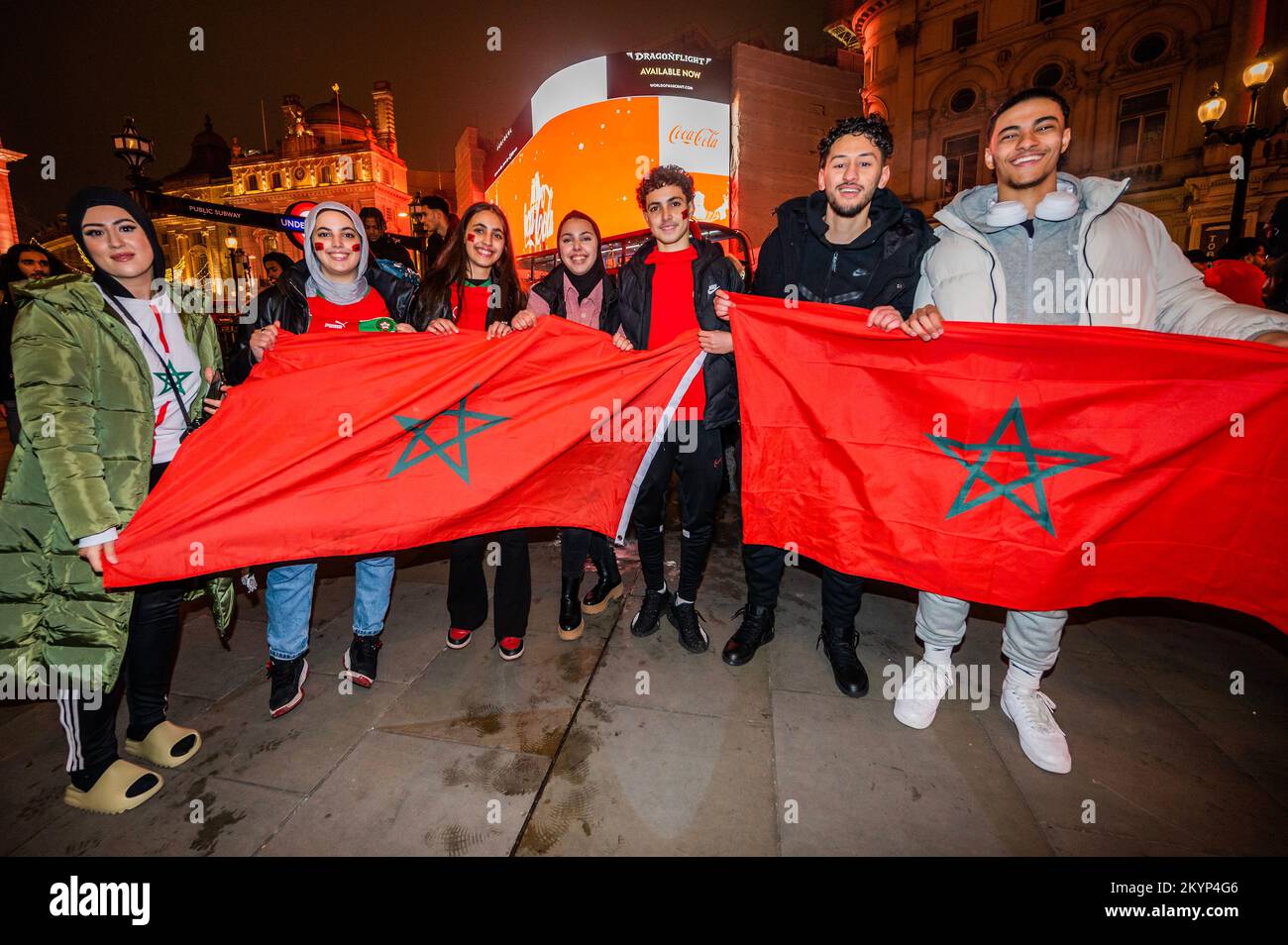London, UK. 1st Dec, 2022. Moroccan fans in Piccadilly Circus celebrate ...