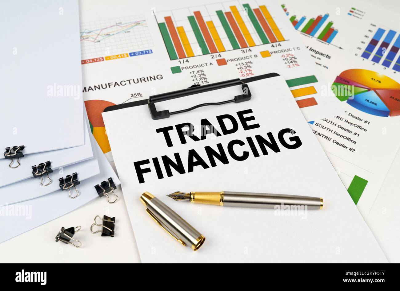 Business concept. On the table among financial graphs and charts lies a ...