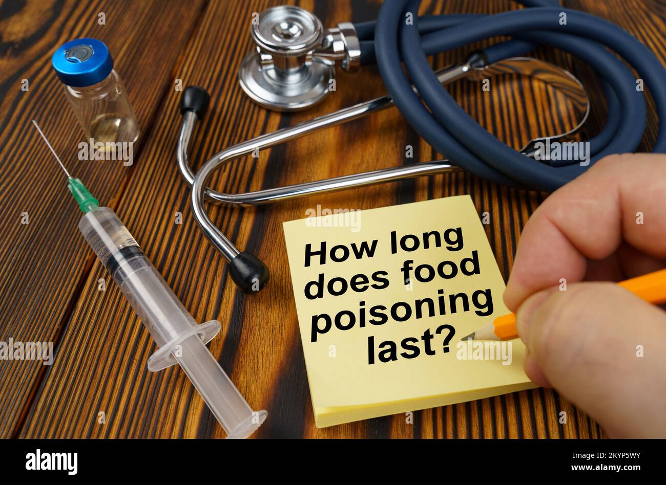 Medical concept. On the table is a stethoscope, a syringe, a man's hand ...