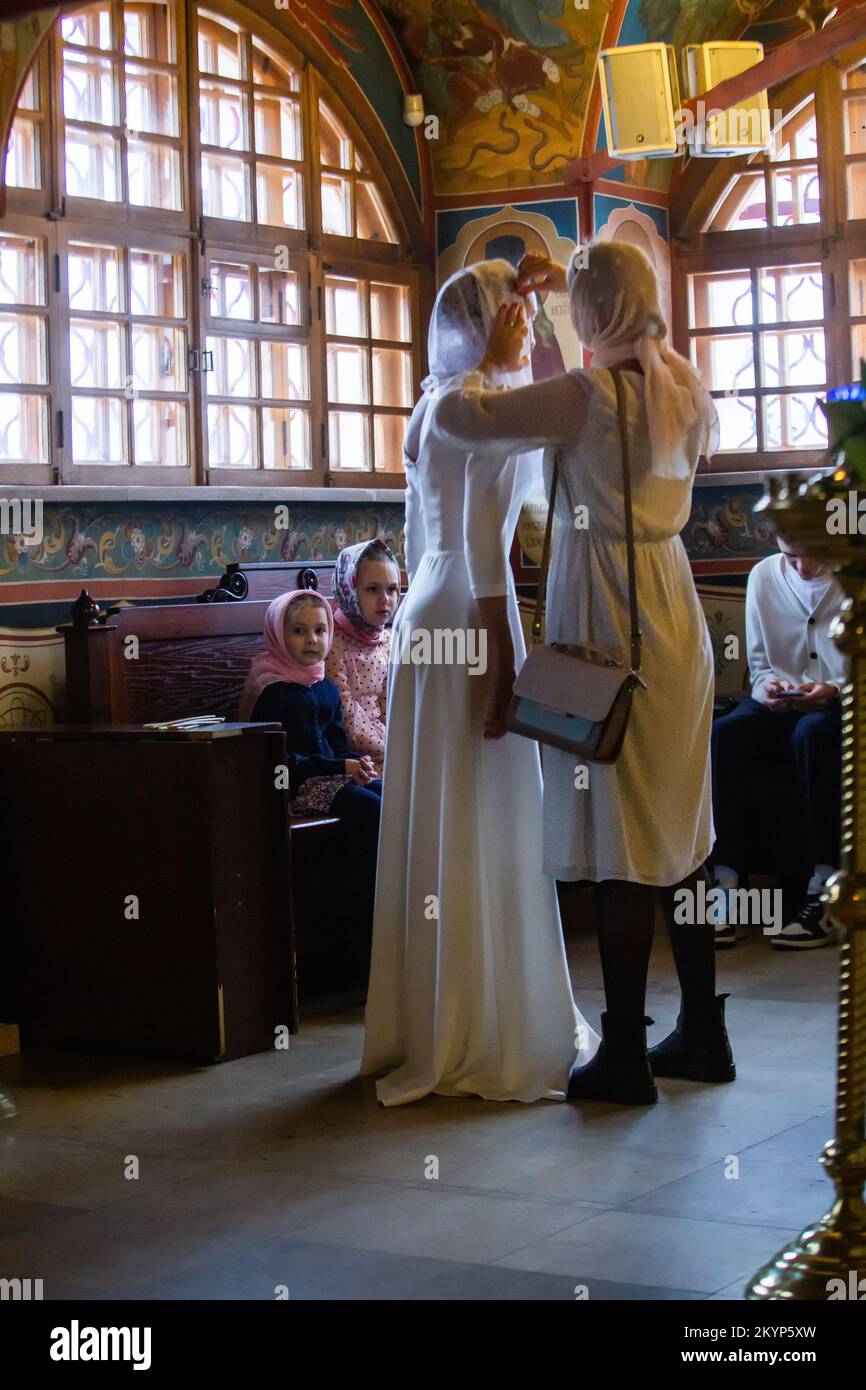11-06-2022 Istra Russia A friend helps the bride get dressed before the ...