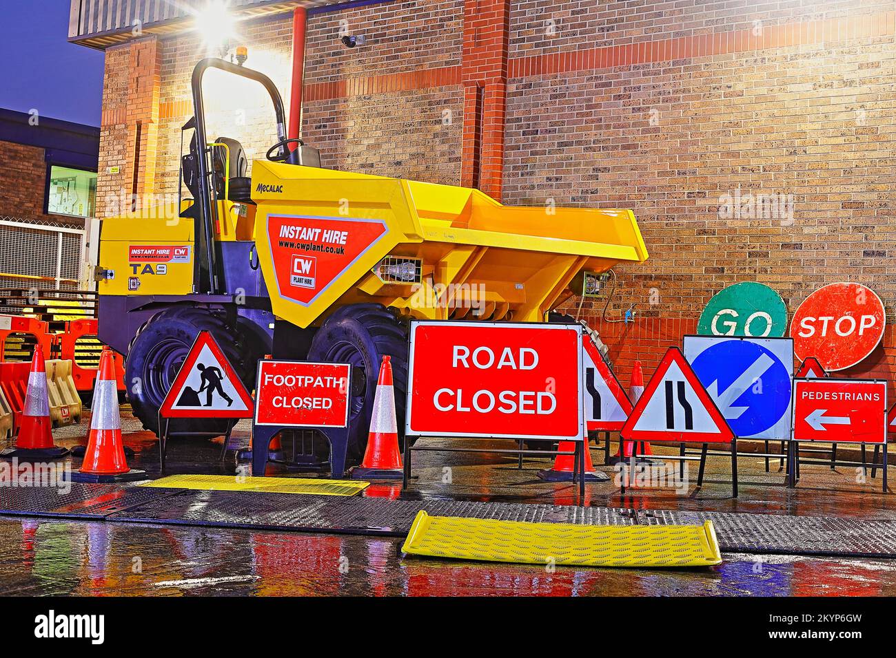 A 9 tonne forward tipping dump truck and road signs at a plant hire ...