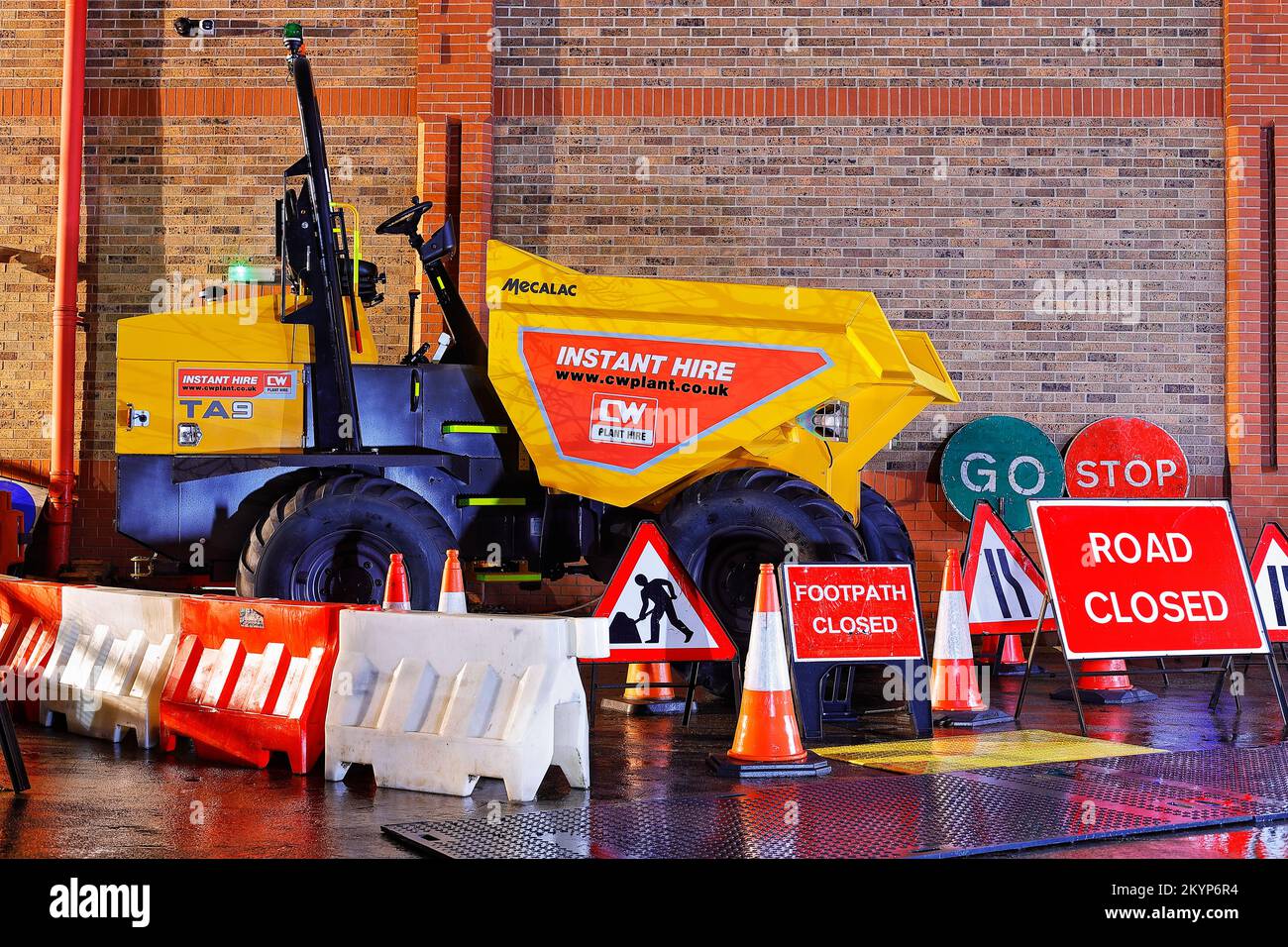 A 9 tonne forward tipping dump truck and road signs at a plant hire ...