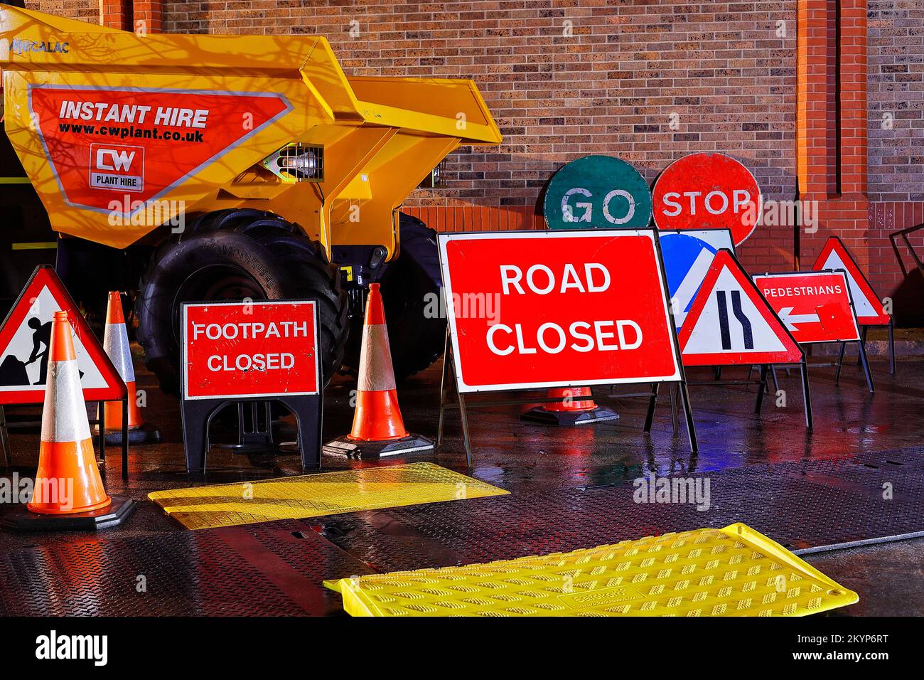 A 9 tonne forward tipping dump truck and road signs at a plant hire ...