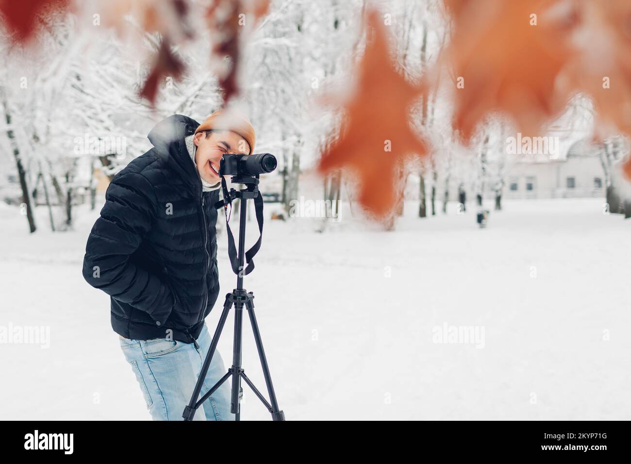 Photographer taking photos using professional digital camera on tripod ...