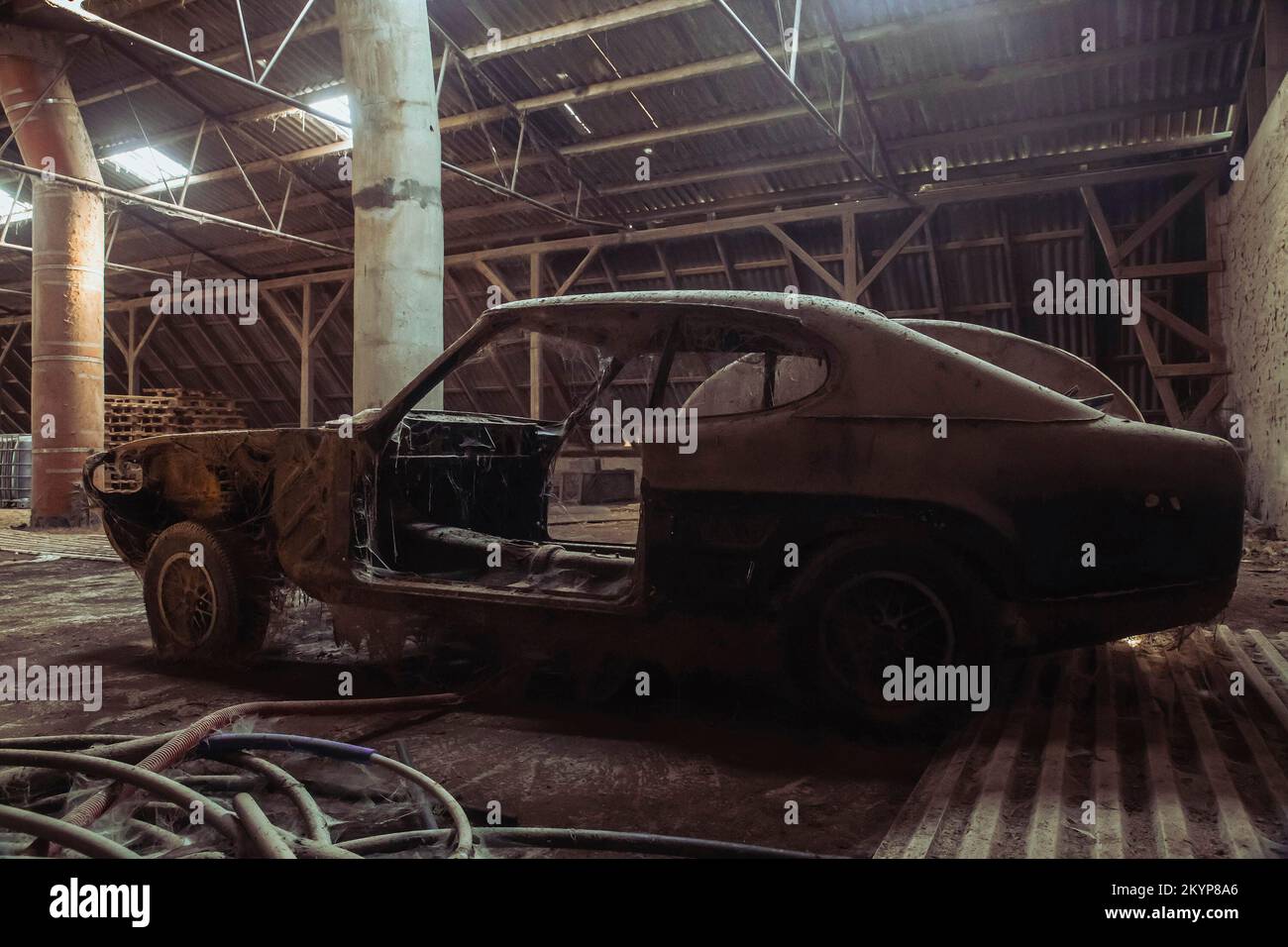 Old disassembled car in an abandoned factory Stock Photo - Alamy