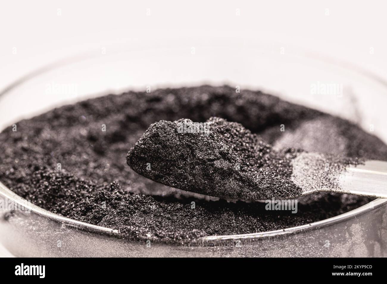 black pigment, powder for industrial or cosmetic use, isolated white ...