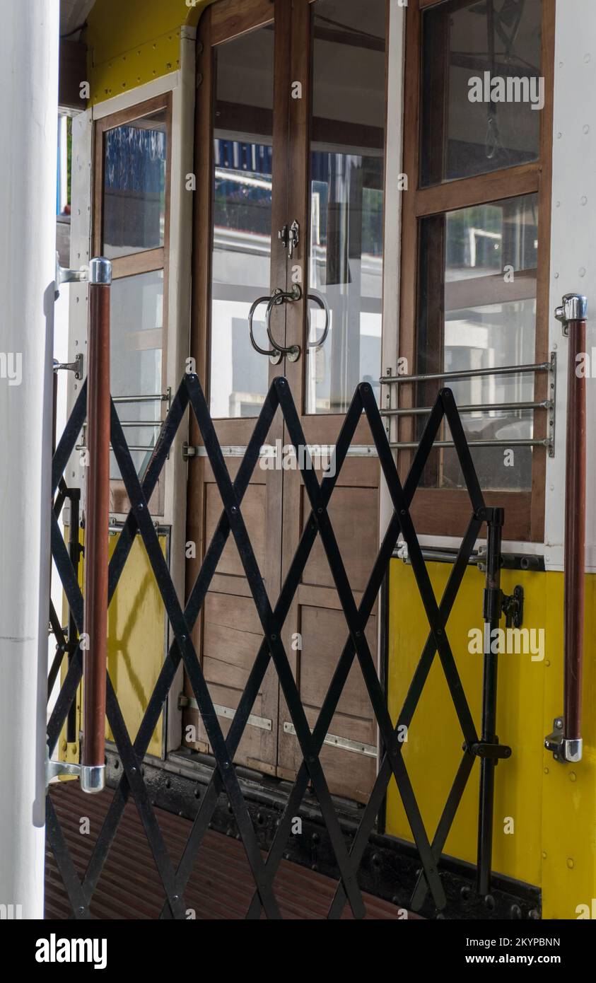 Entrance to the ancient yellow Portuguese tram with wooden door ...