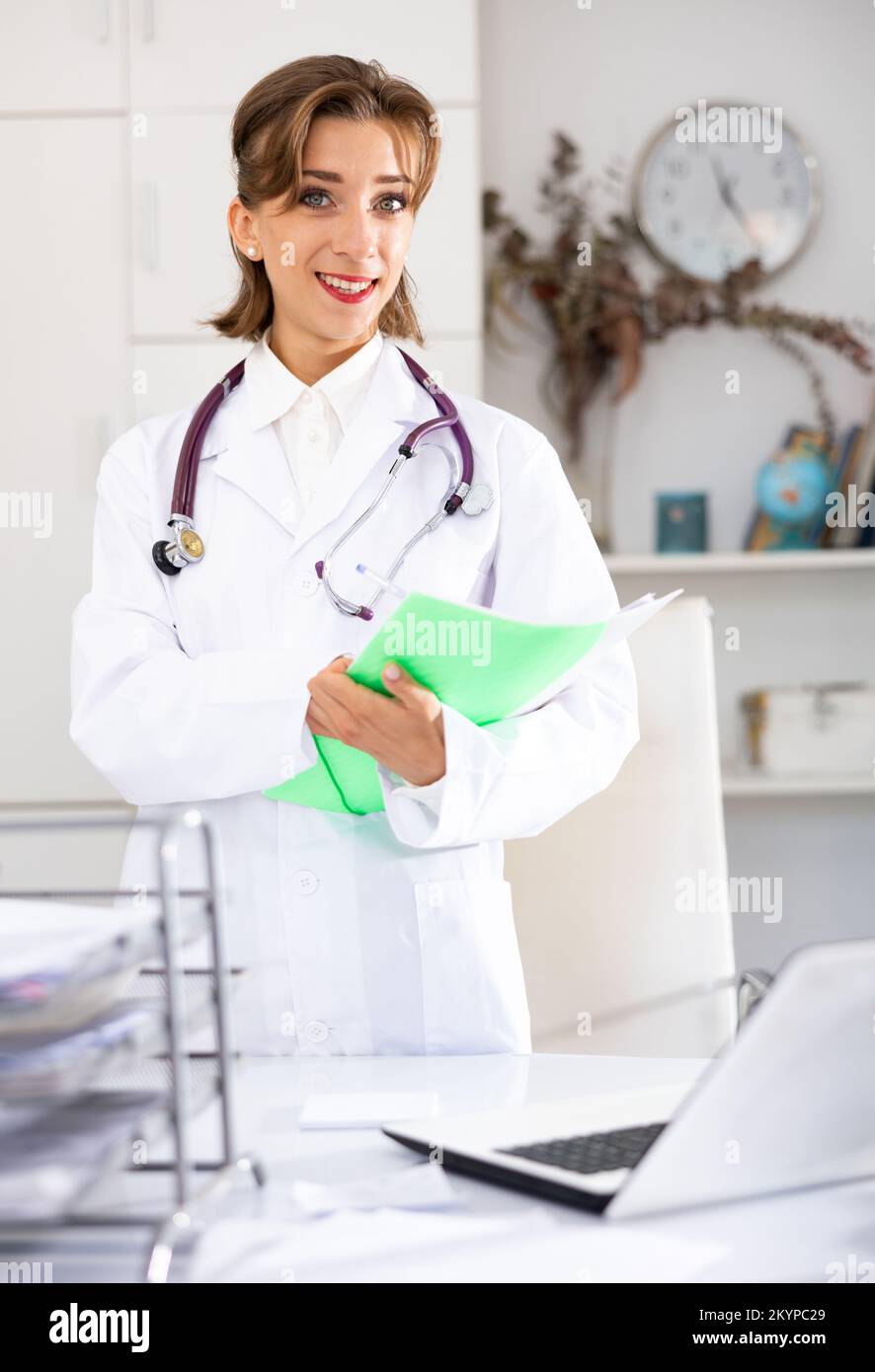 Woman doctor wear white medical uniform and stethoscope with folder of ...