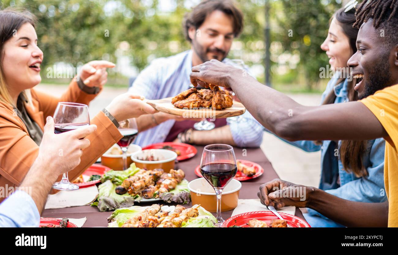Group multi-ethnic friends having lunch at farmhouse table - Diverse ...