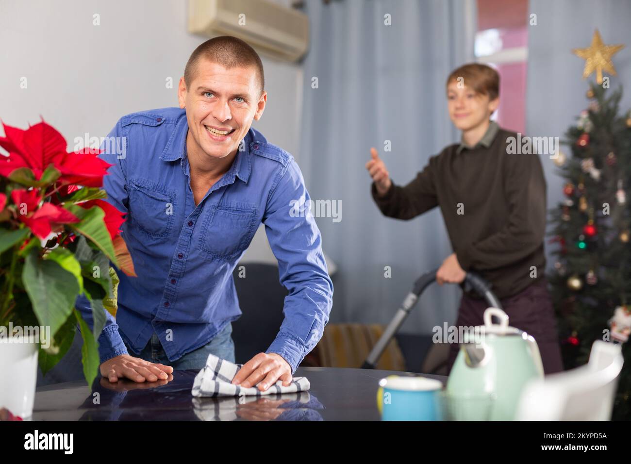 Father and son cleaning room together before christmas Stock Photo - Alamy