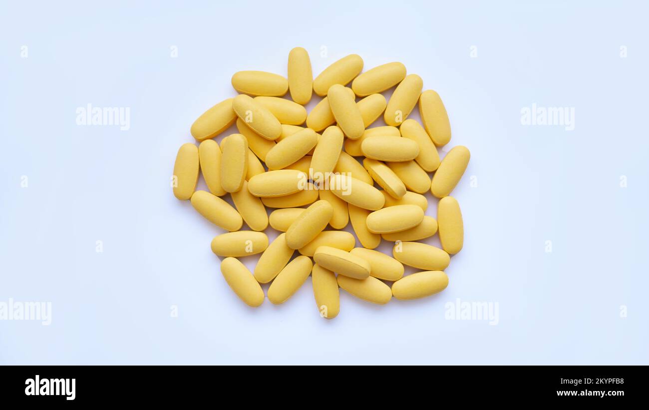 Close-up texture of yellow multivitamin tablets on white background ...