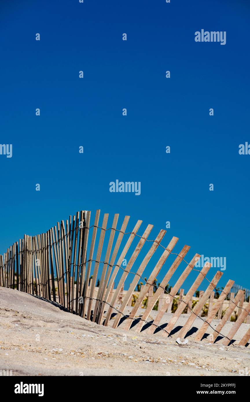 Twisted fence on an empty beach Stock Photo - Alamy