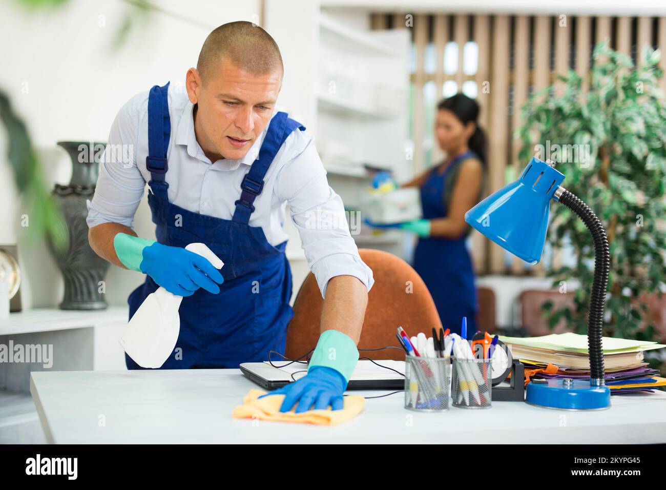 Positive professional spanish cleaner cleaning hi-res stock photography ...