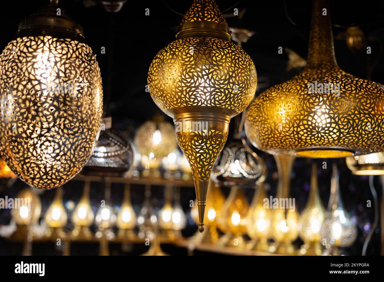 Bright openwork hanging metal lamps of an unusual shape Stock Photo - Alamy