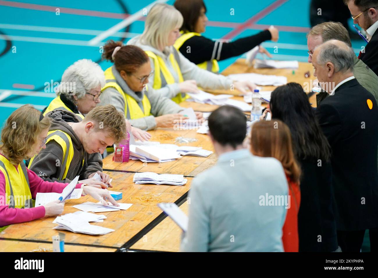 Party officials observe the count during the count at Northgate Arena ...