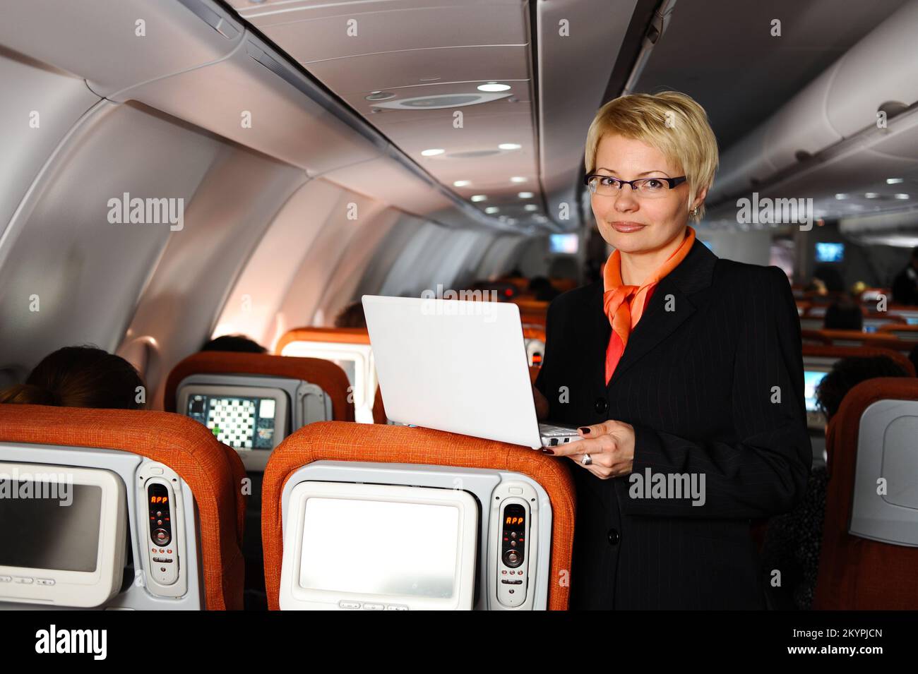 Business woman posing in modern jet aircraft Stock Photo - Alamy