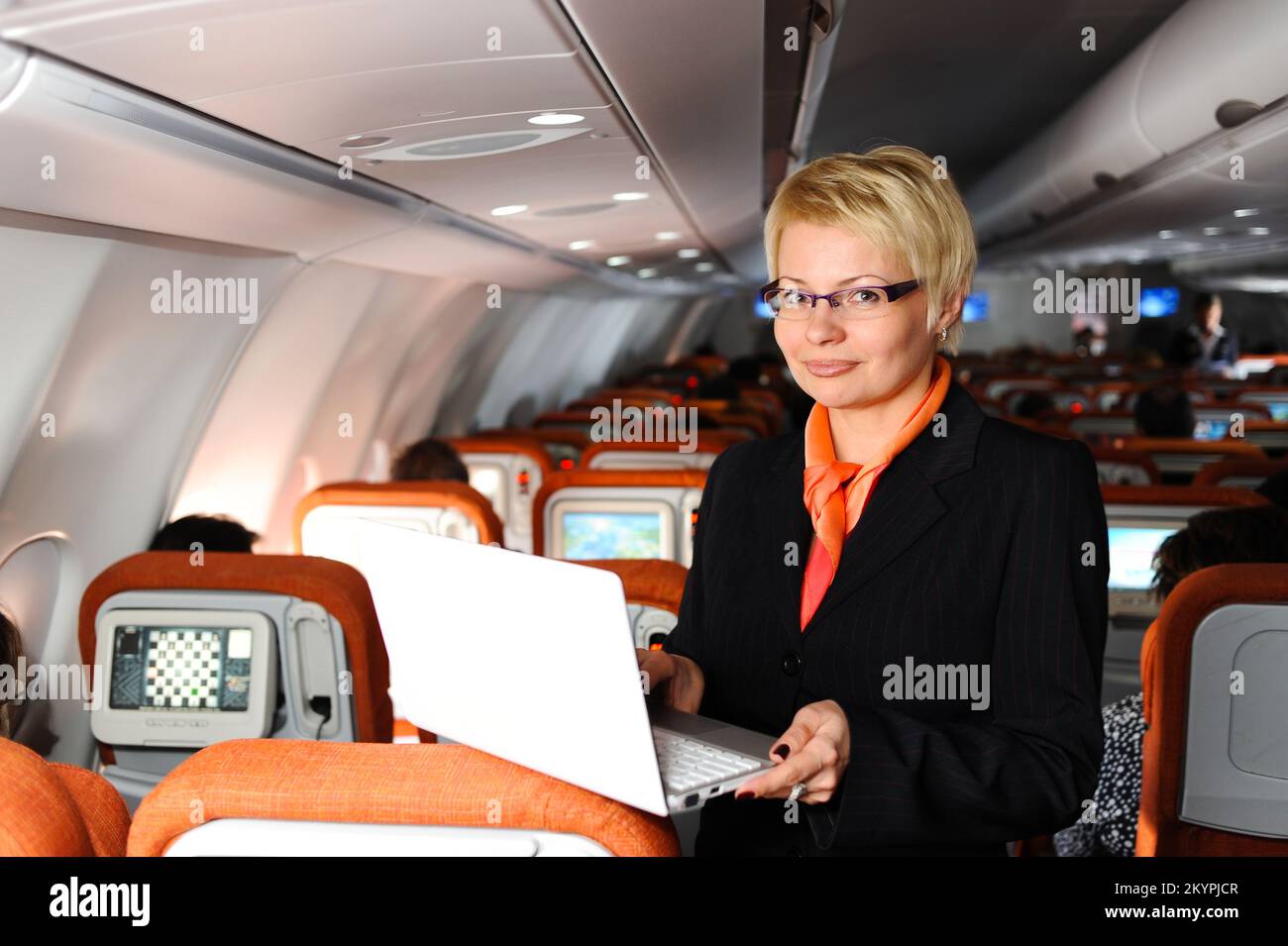 Business woman posing in modern jet aircraft Stock Photo - Alamy