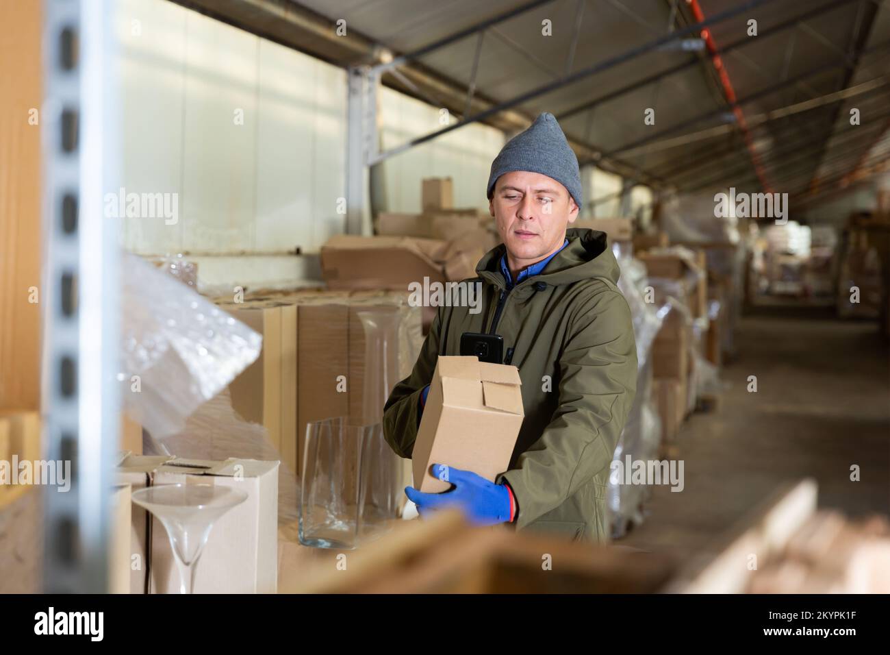 Storekeeper using his phone to take photograph of pasteboard box Stock ...