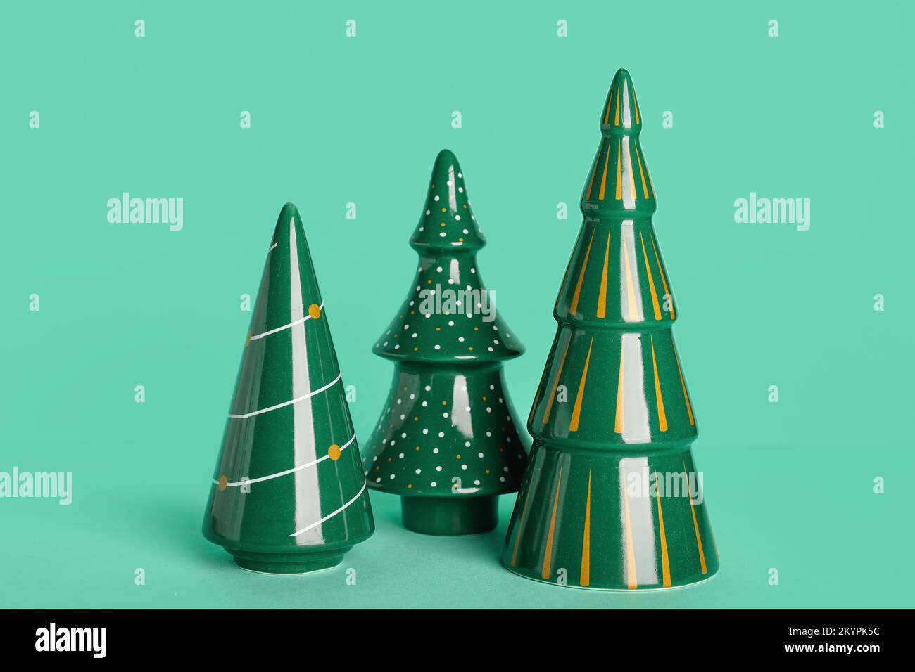 Beautiful ceramic Christmas trees on color background Stock Photo - Alamy