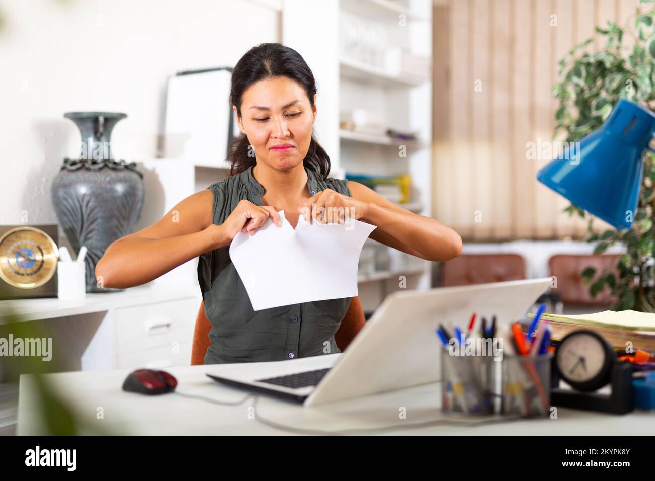 Upset asian female employee manager at working place Stock Photo - Alamy