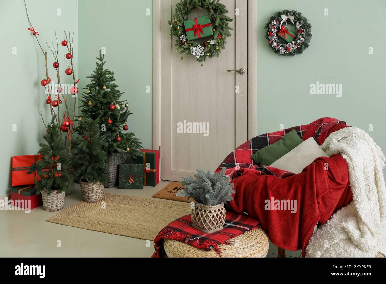 Interior of hall with wooden door, Christmas decor and armchair Stock ...