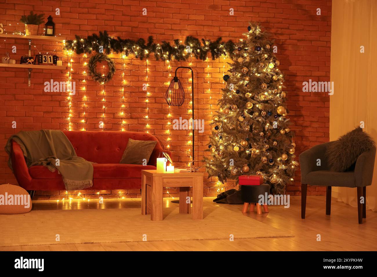 Interior of living room with Christmas tree, sofa and glowing lights at ...