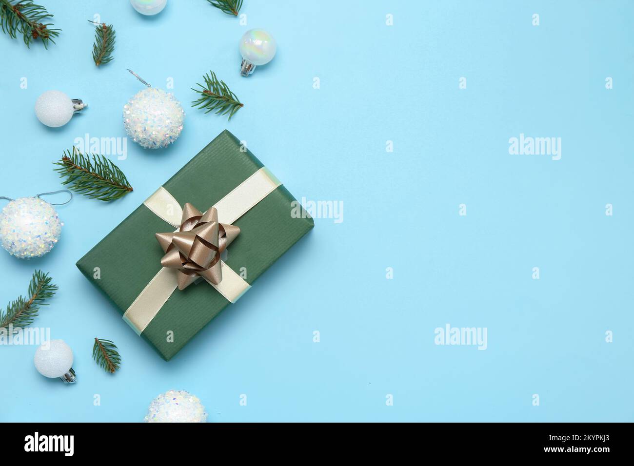 Christmas gift box with balls and fir branches on blue background Stock ...