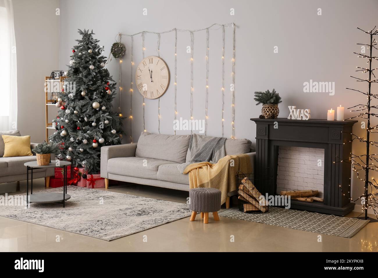 Interior of living room with glowing Christmas tree, sofa and ...