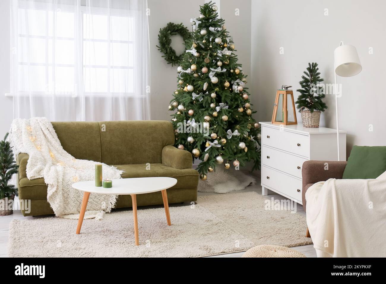 Interior of living room with glowing Christmas trees, sofa and drawers ...