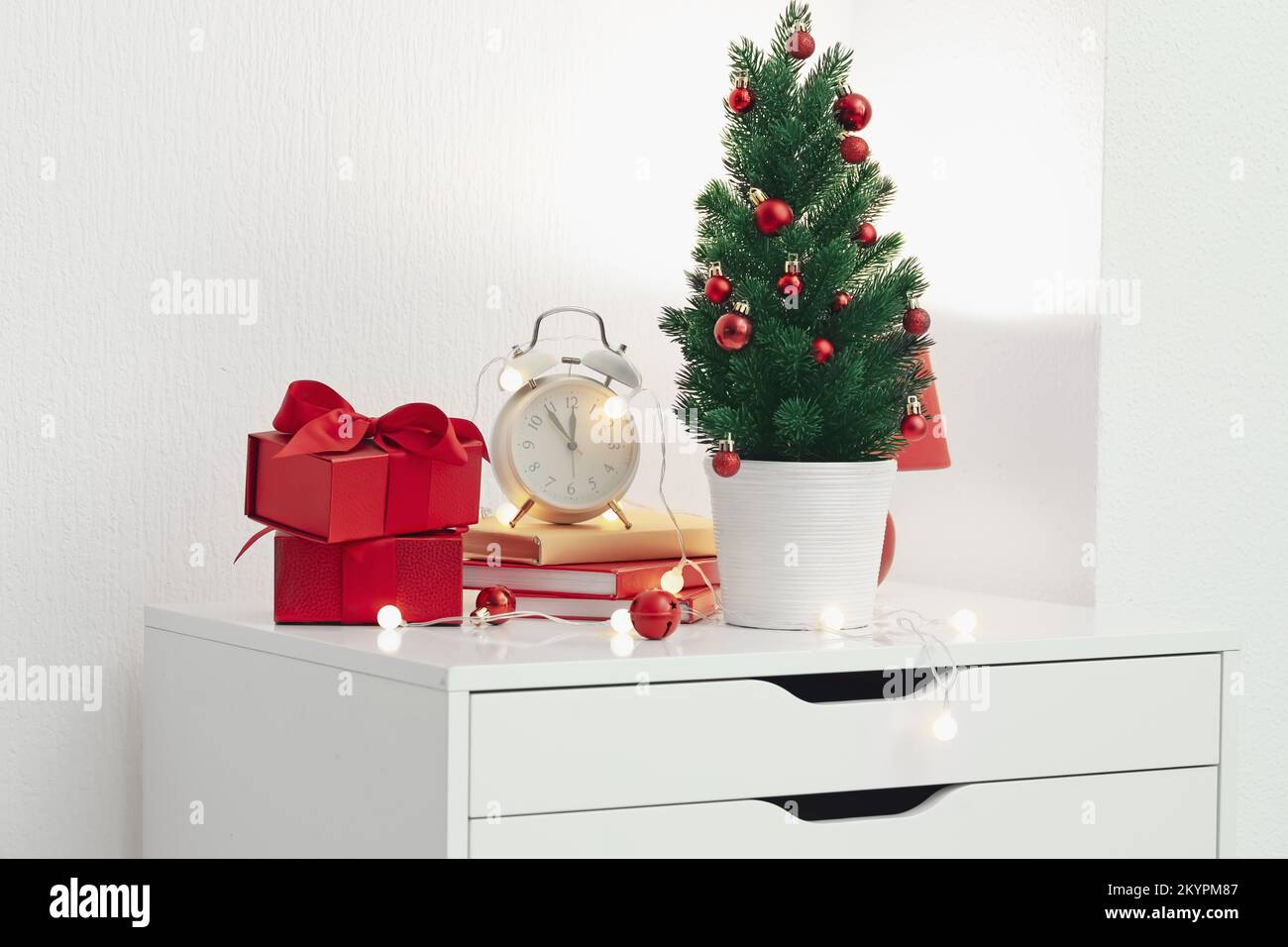 Small Christmas tree, alarm clock, books, presents and glowing lights ...
