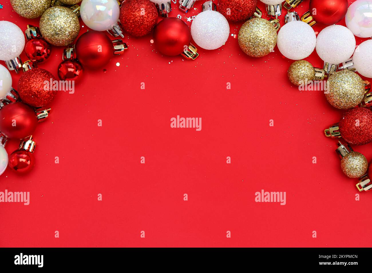 Frame made of beautiful Christmas balls on red background, top view ...